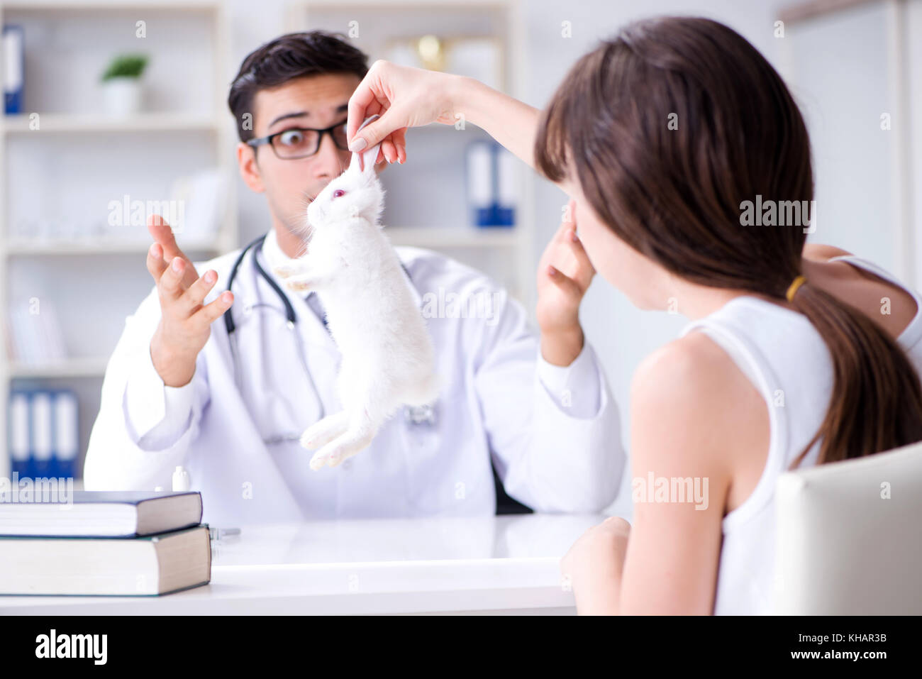 Woman with pet rabbit visiting vet doctor Stock Photo - Alamy