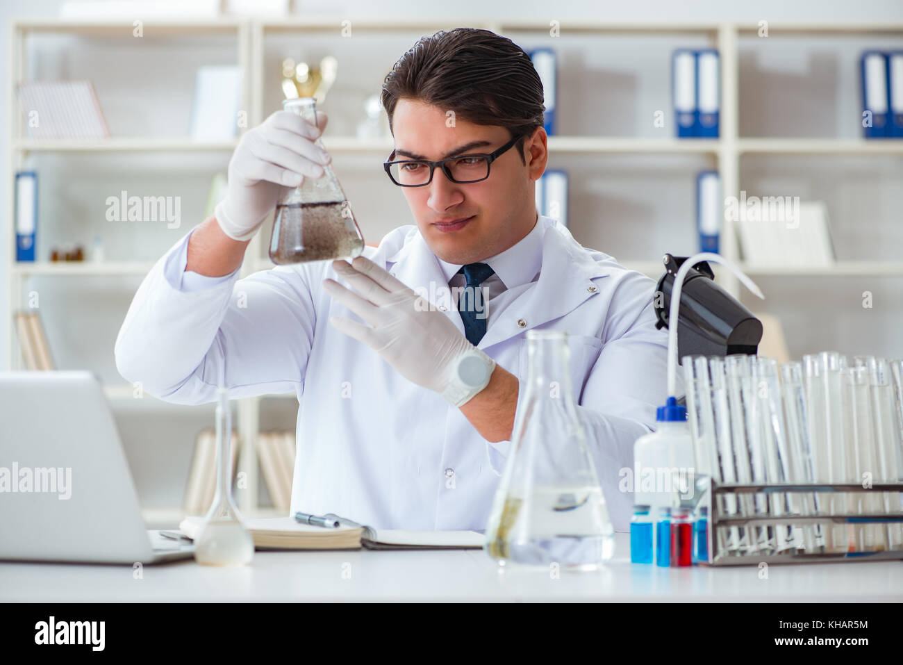 Young researcher scientist doing a water test contamination experiment ...