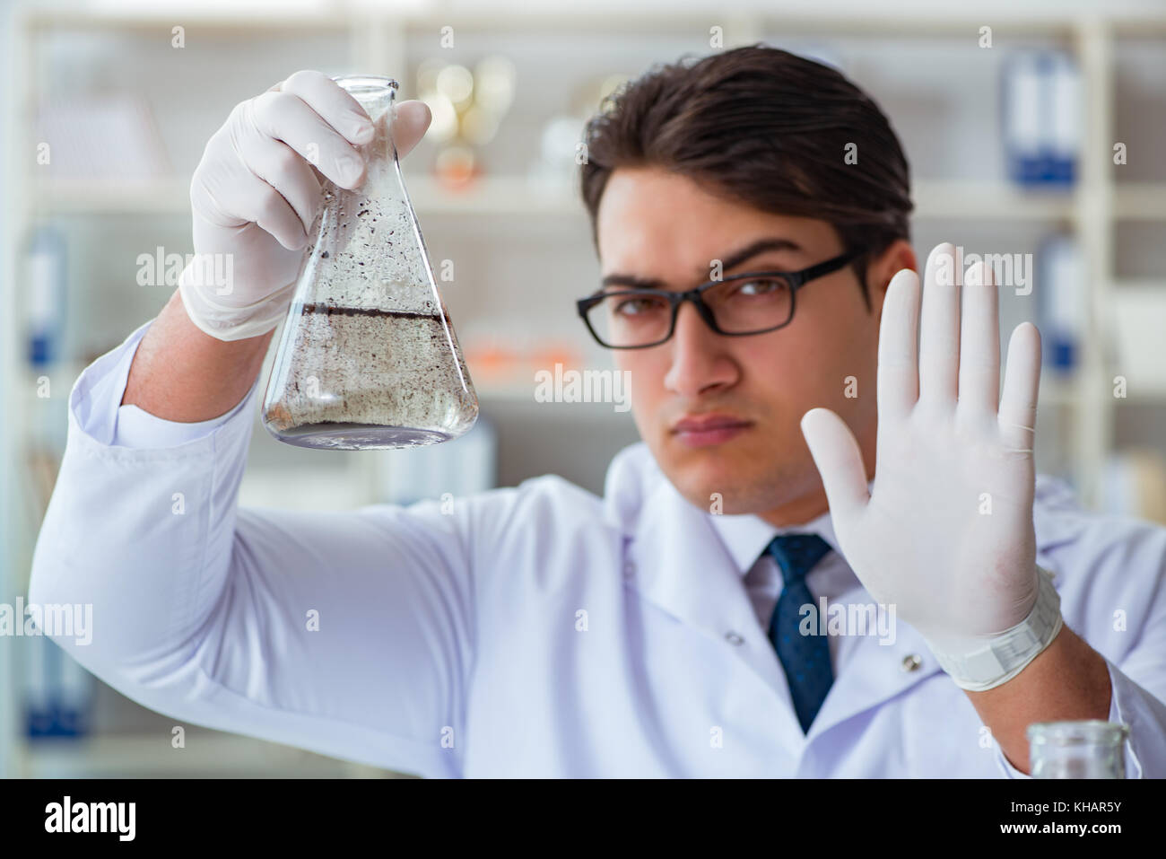 Young researcher scientist doing a water test contamination experiment ...