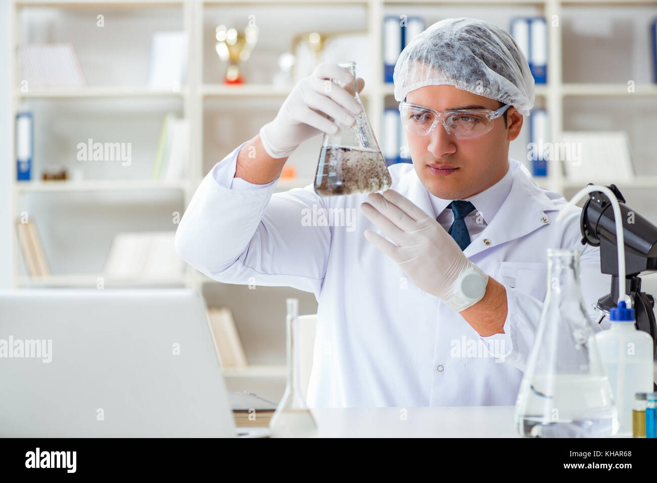 Young researcher scientist doing a water test contamination experiment ...