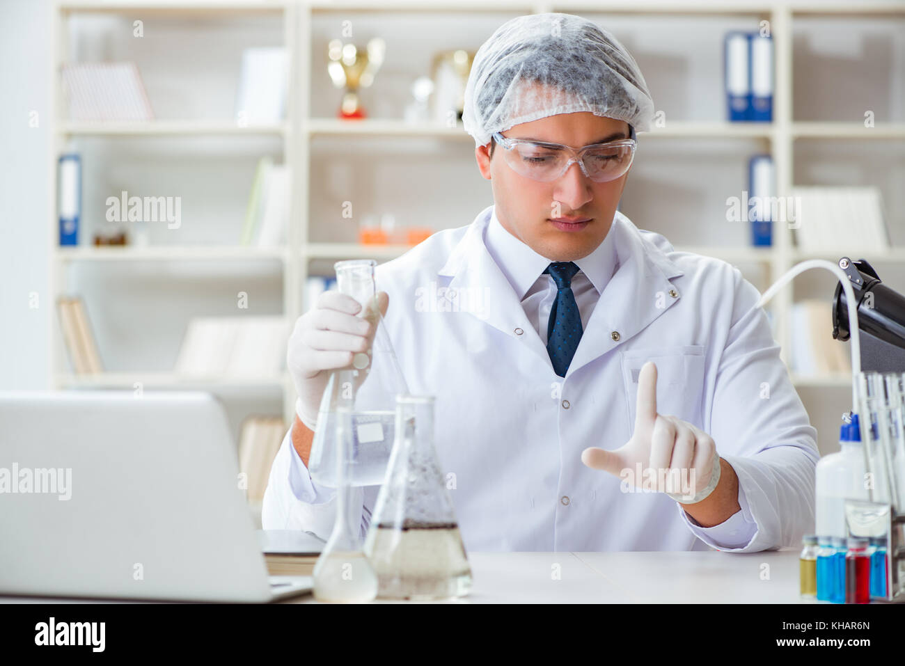 Young researcher scientist doing a water test contamination experiment ...