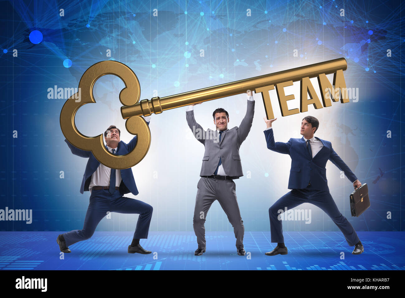 Businessmen holding giant key in team concept Stock Photo - Alamy