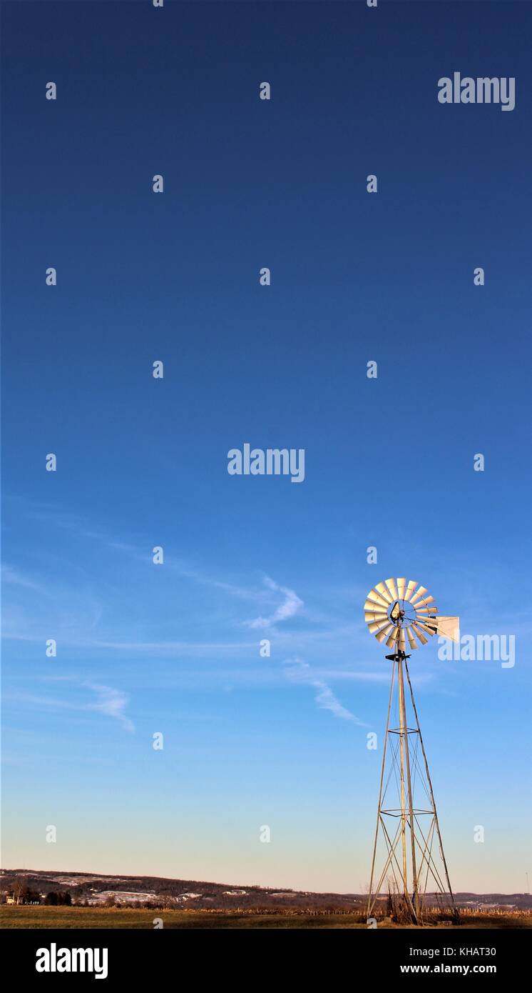 Metal Windmill in a large field Stock Photo - Alamy