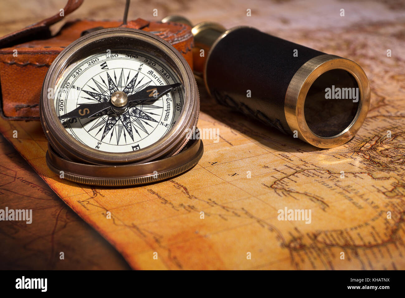 Brass compass and telescope on a map Stock Photo - Alamy