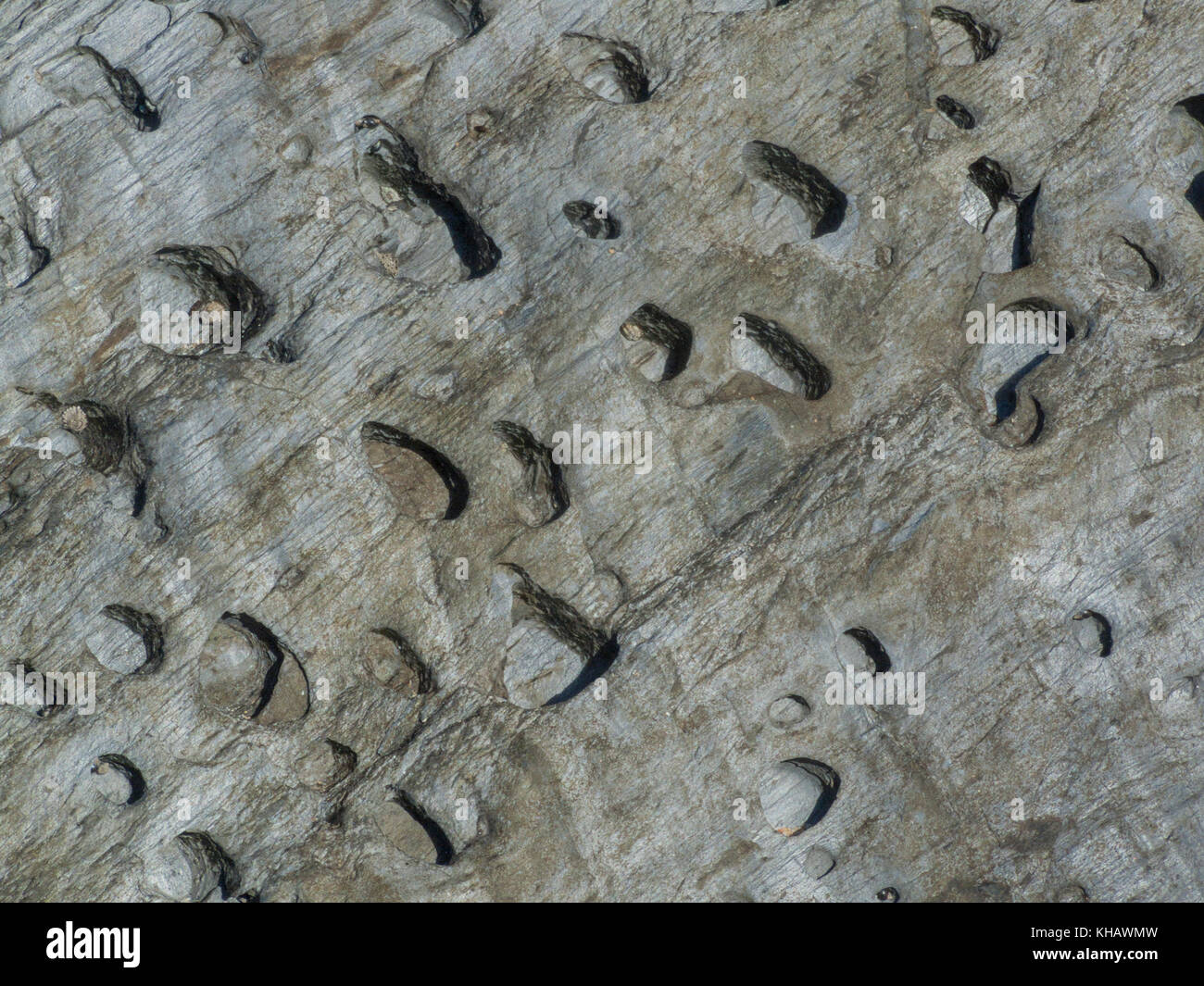 Section of stone cliff face which has been naturally weathered ...