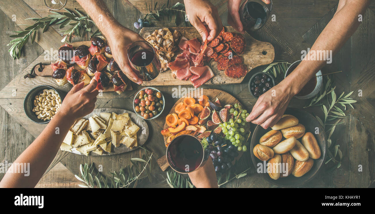 Top view of people drinking, eating together and holding glasses Stock ...