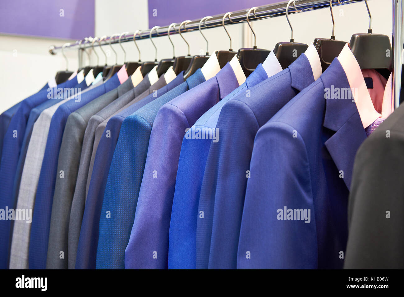 Men's suits with shirts in the clothing store Stock Photo - Alamy