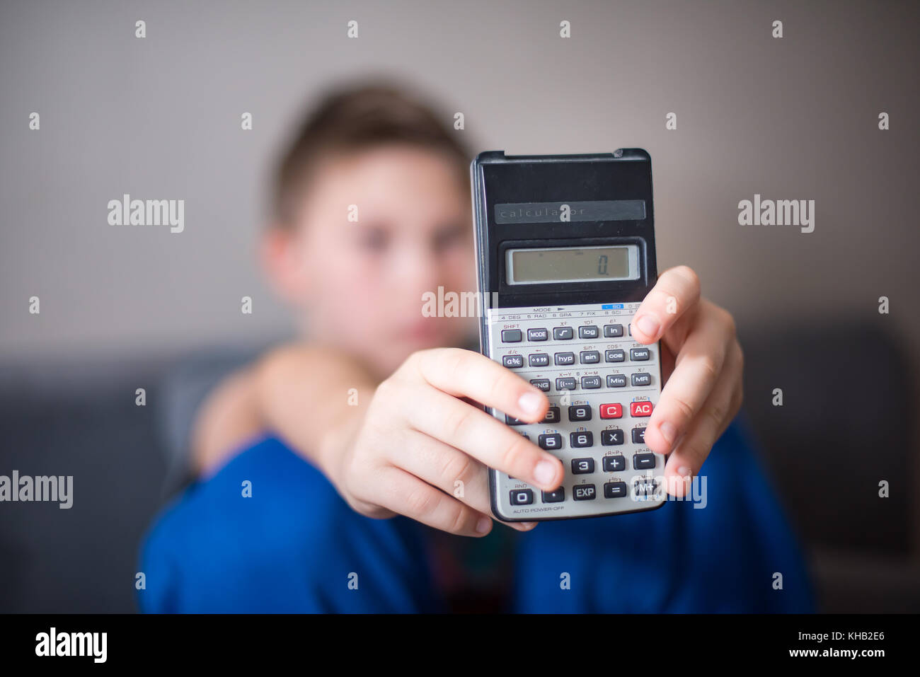School boy presenting calculator with zero digit displayed on it Stock ...