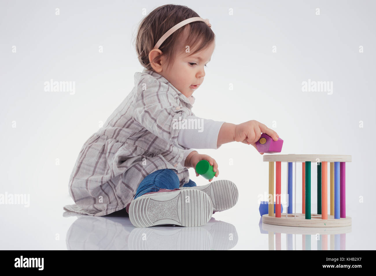 Cute baby girl playing wooden cubes isolated on white background Stock ...