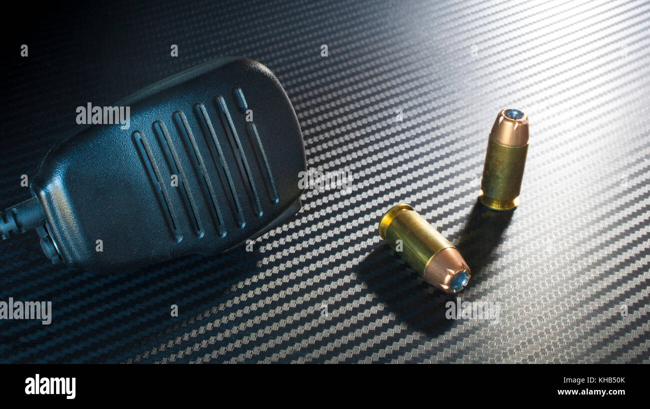 Self defense ammo for a handgun and a police microphone Stock Photo - Alamy