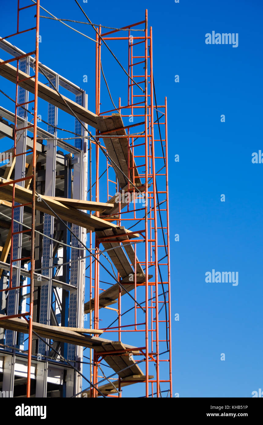scaffolding around the building under construction against a bright ...