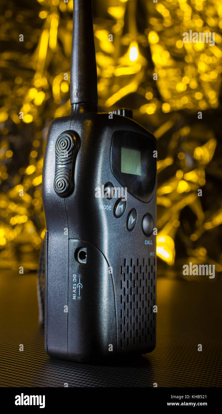 Walkie-talkie for very high frequency transmissions with yellow behind ...
