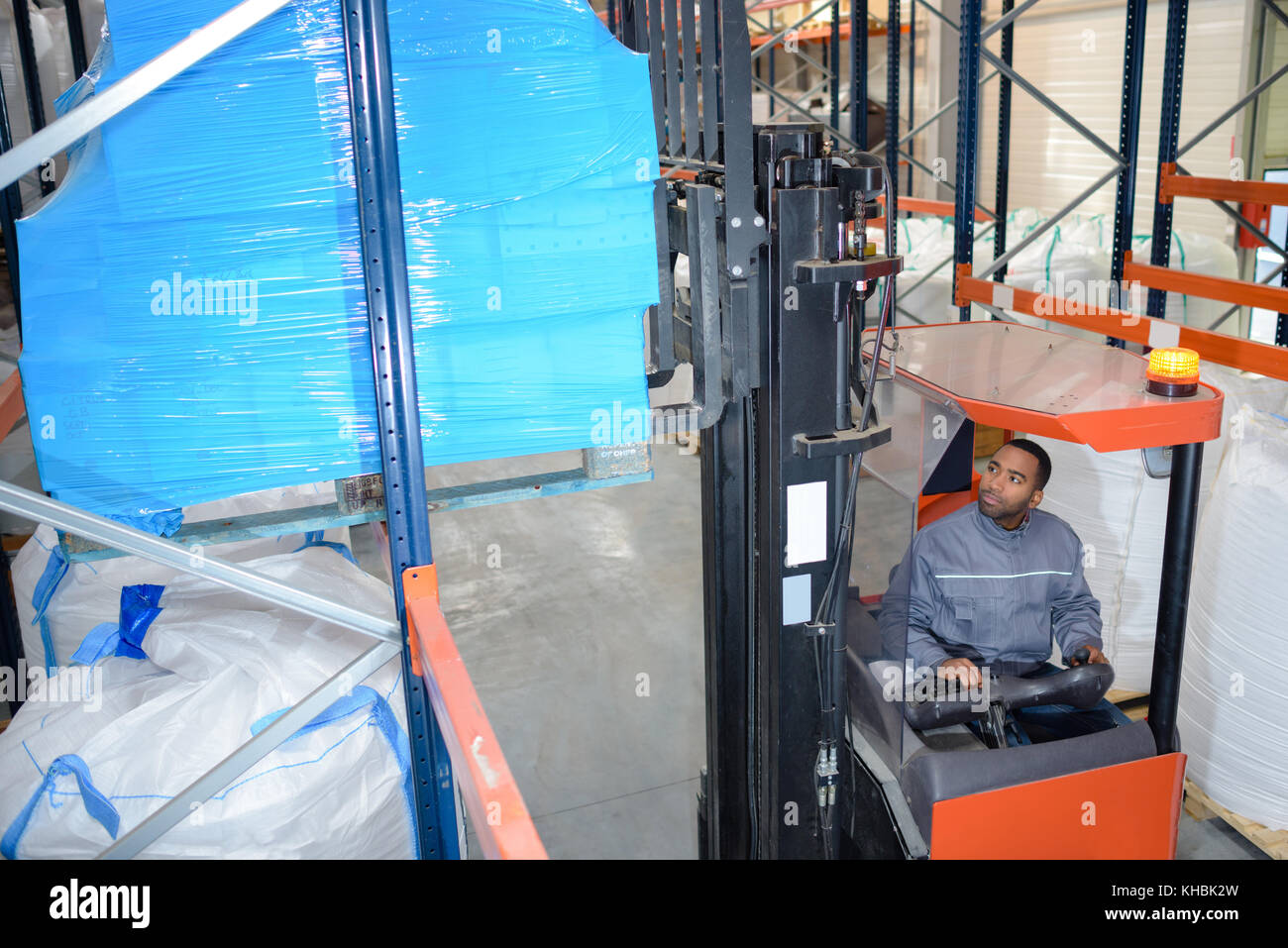man on forklift loader loading boxes at warehouse Stock Photo - Alamy