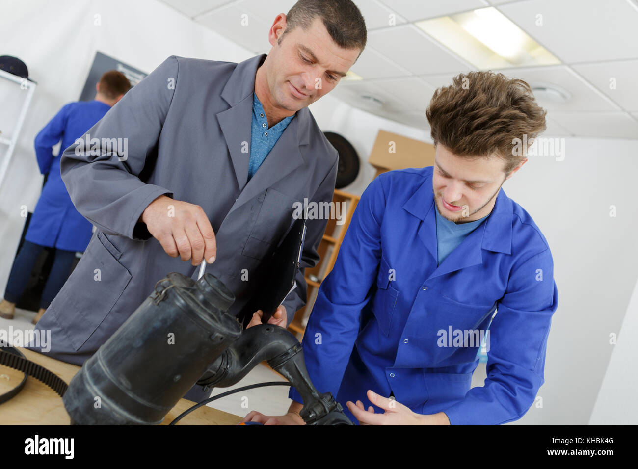 apprentice studying a plumbing object Stock Photo - Alamy