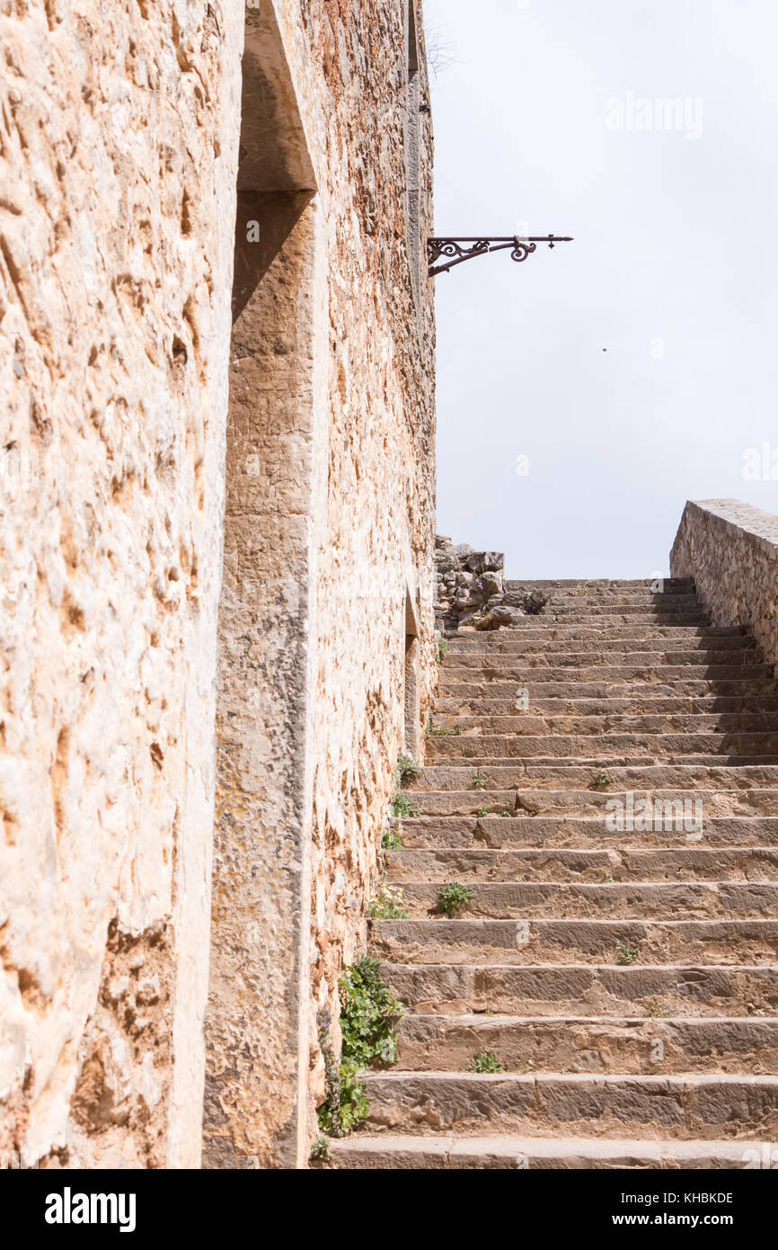 Stone wall with portal and stairway of a medieval fortress, side view ...
