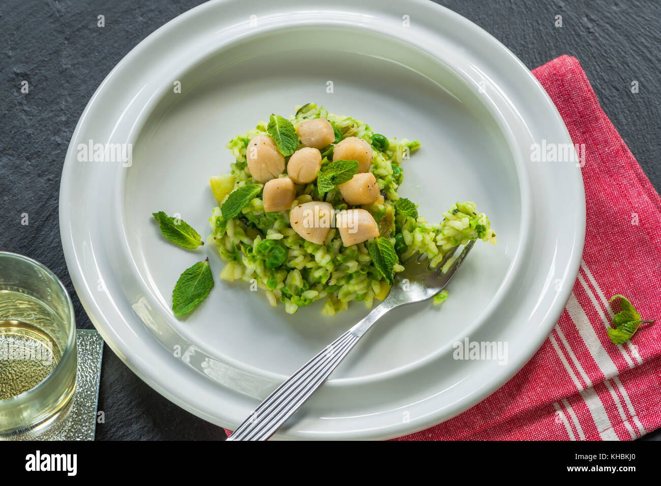 Scallops on minted pea risotto garnished with fresh mint Stock Photo ...