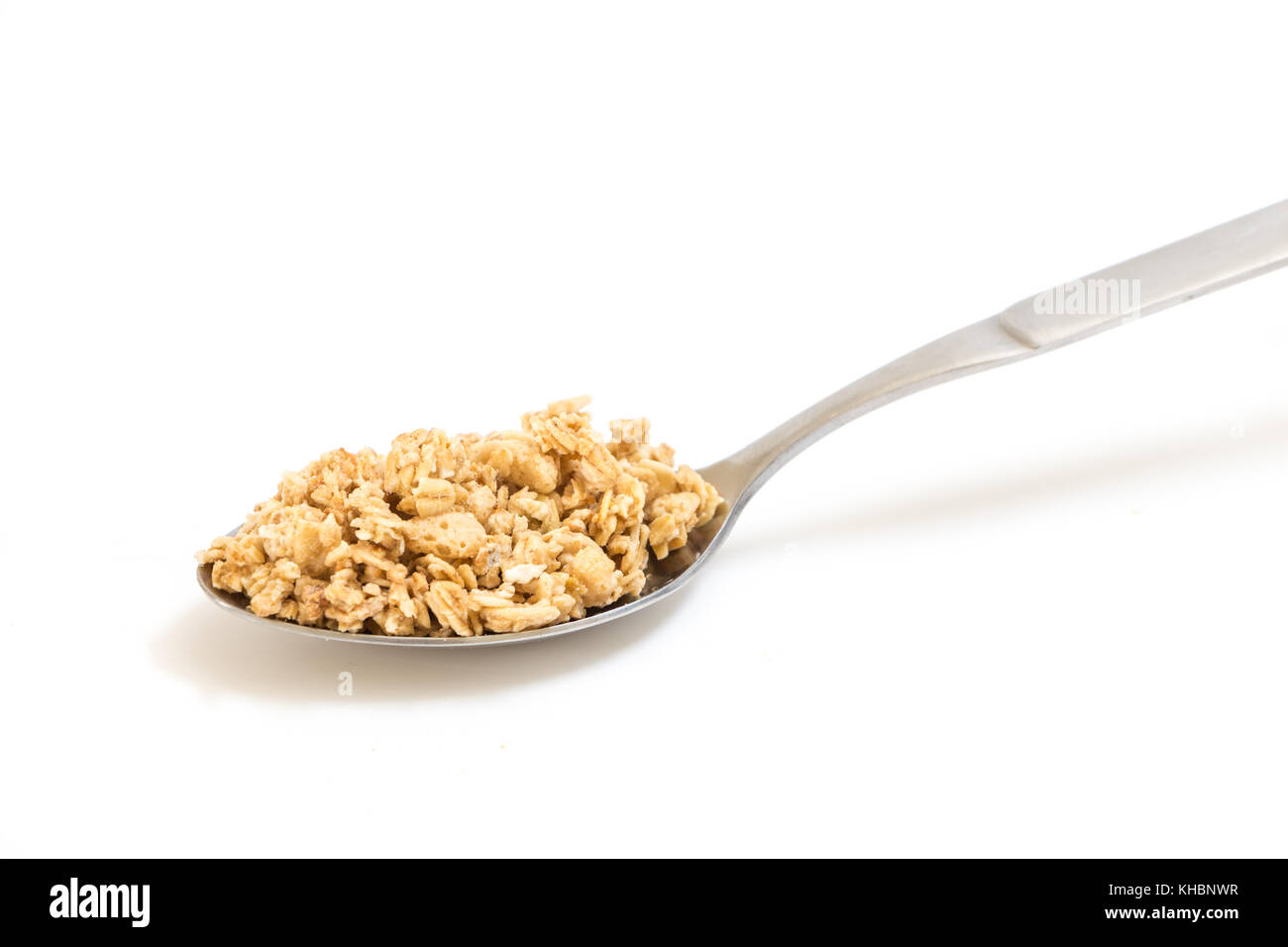 Spoon with granola, on white background Stock Photo - Alamy