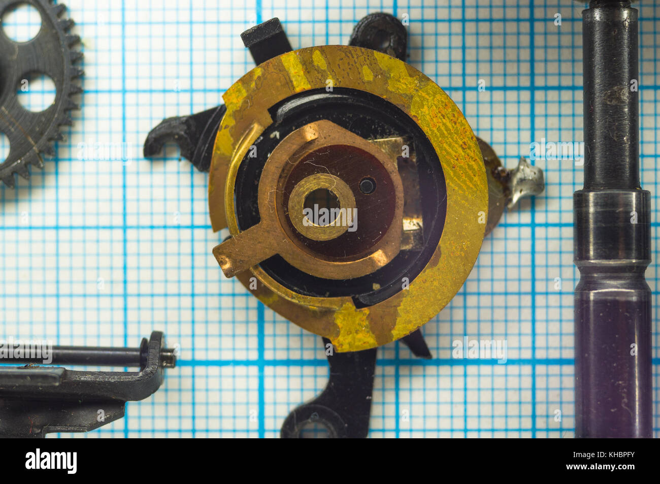 parts are completely disassembled old retro film SLR camera on graph ...