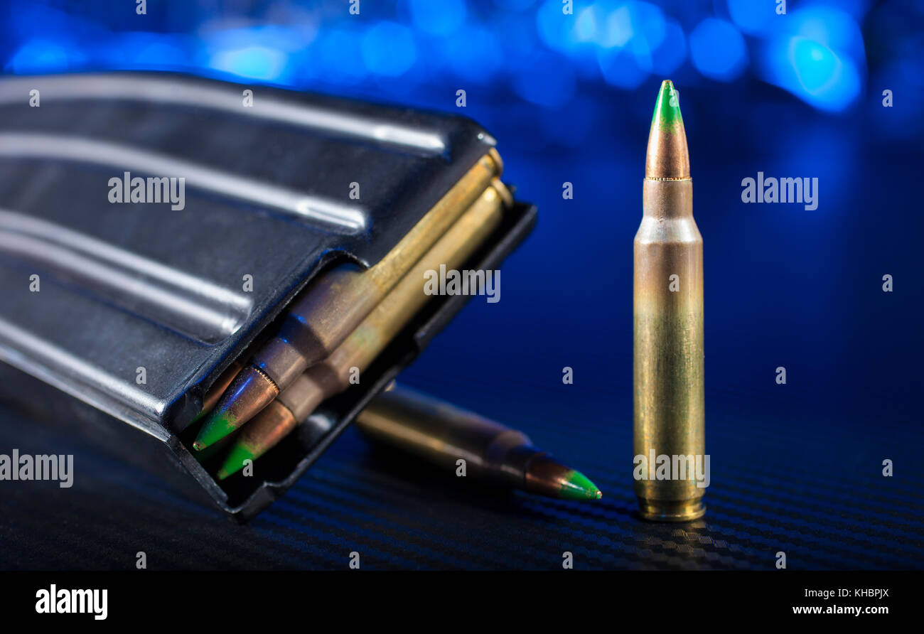 AR-15 cartridges next to a magazine with blue background Stock Photo ...