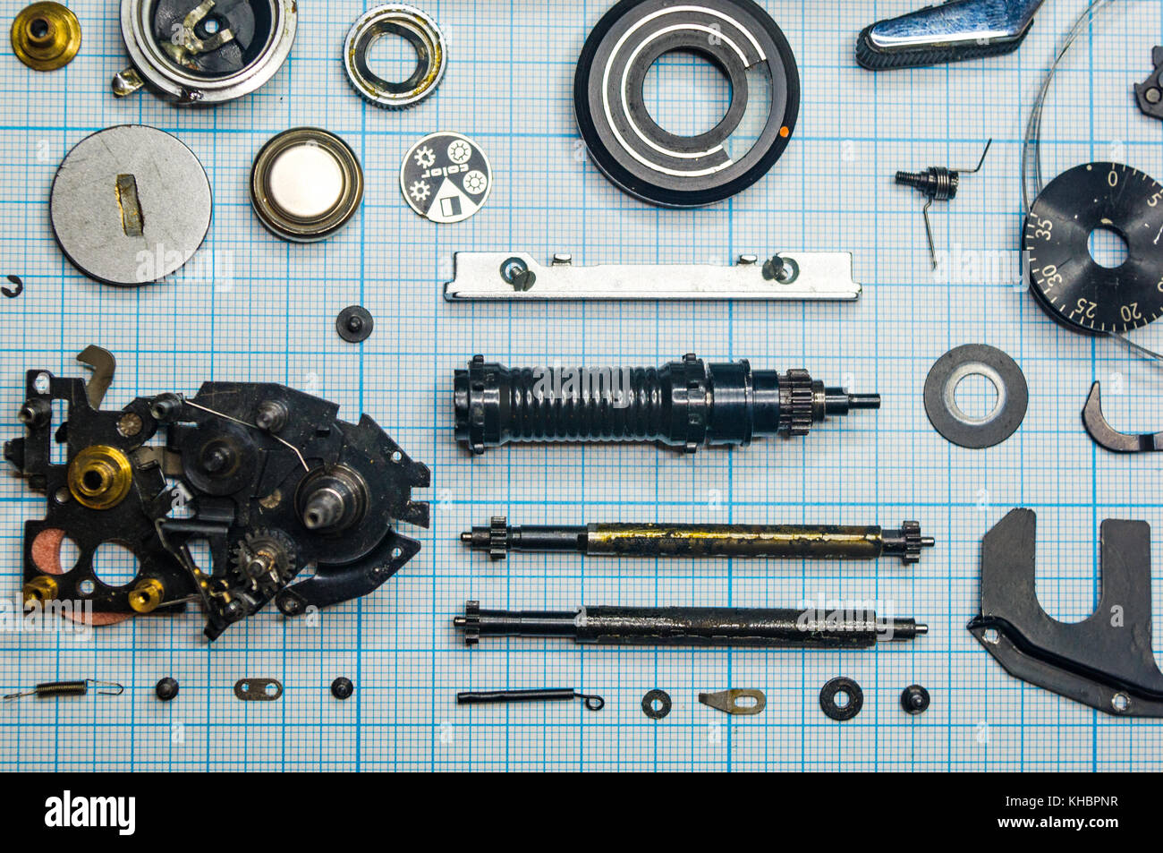 parts are completely disassembled old retro film SLR camera on graph ...