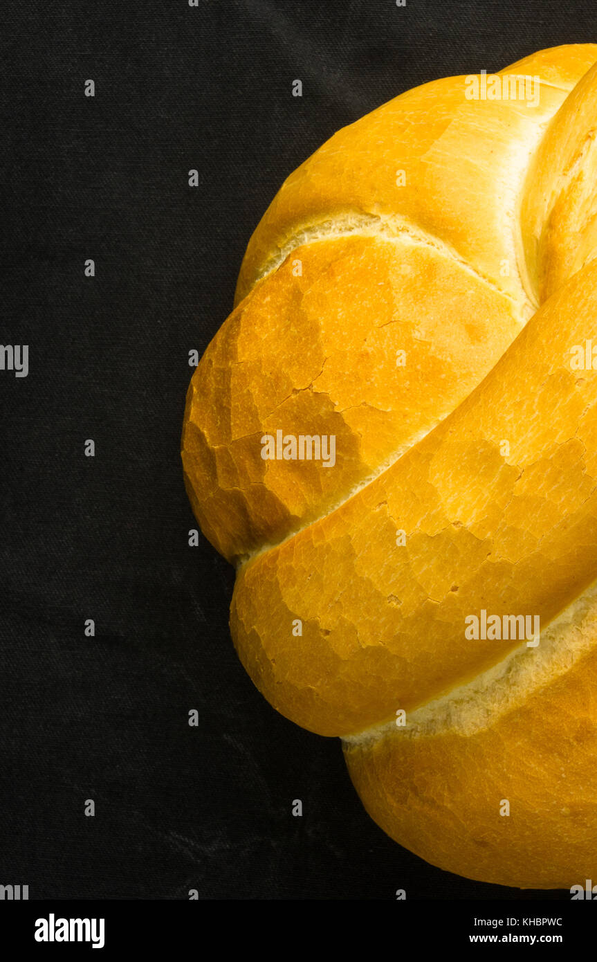fresh braided loaf of white wheat bread on black background Stock Photo ...