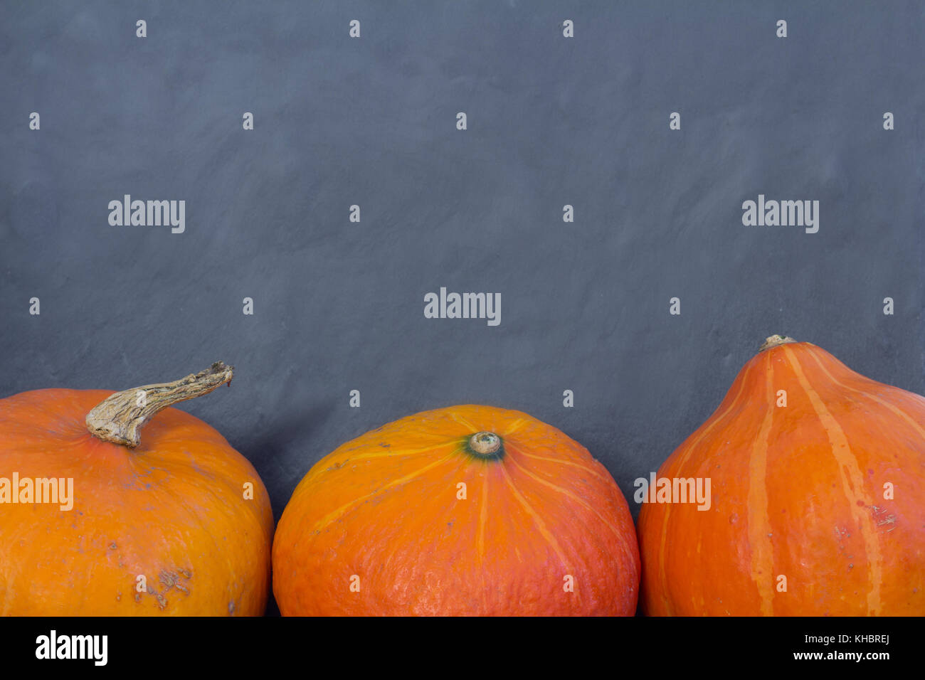 three pumpkins on black background Stock Photo - Alamy