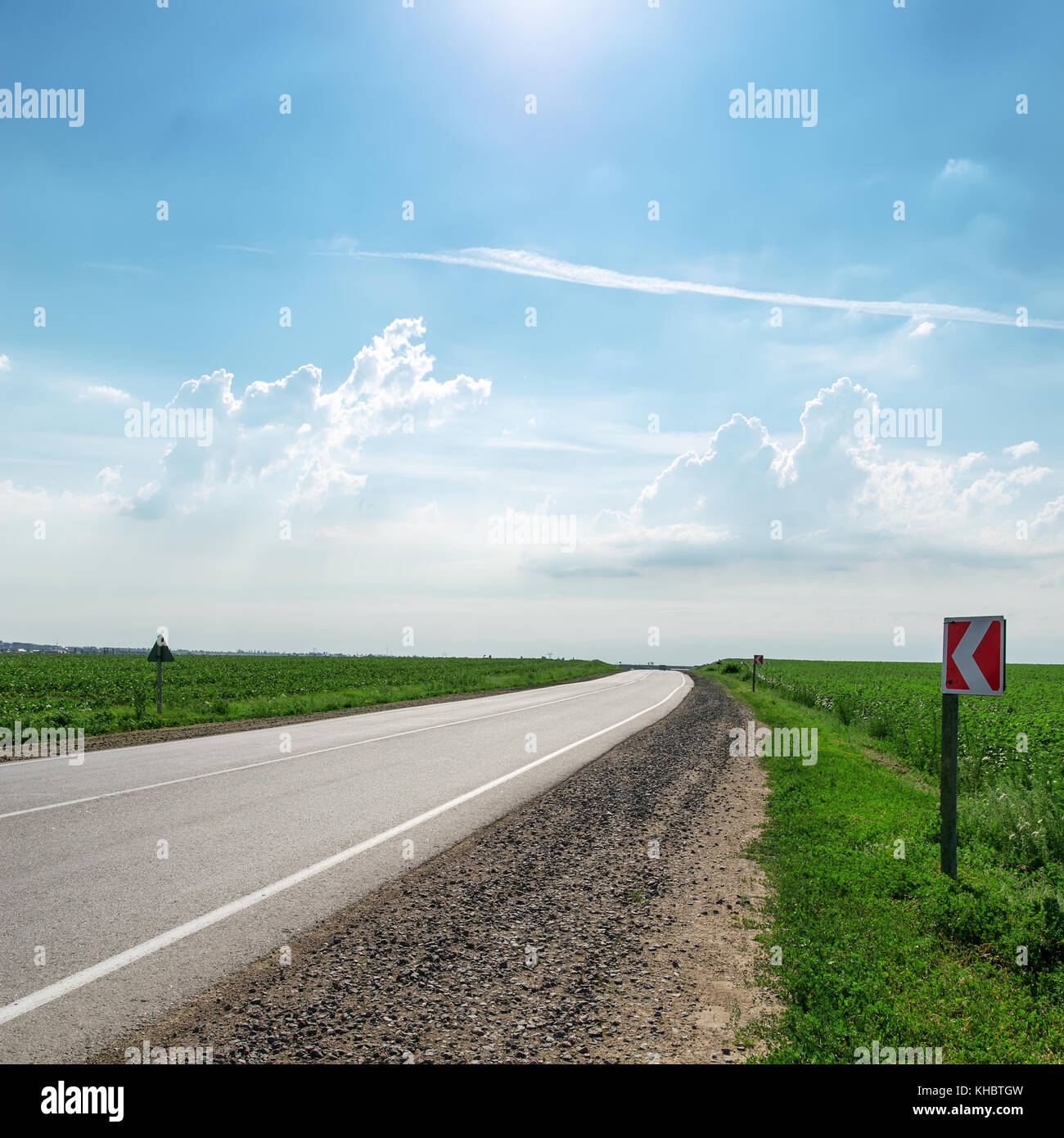 asphalt road under sun in sky Stock Photo - Alamy