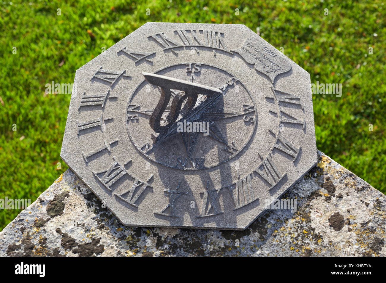OCTOBER 22, 2017 - Sundial in morning sunshine with blurred green grass ...