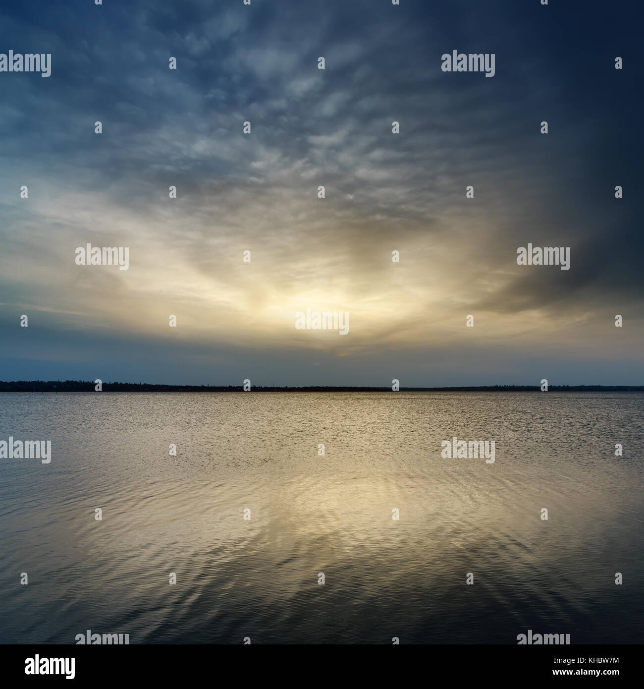 sunset over dark water Stock Photo - Alamy