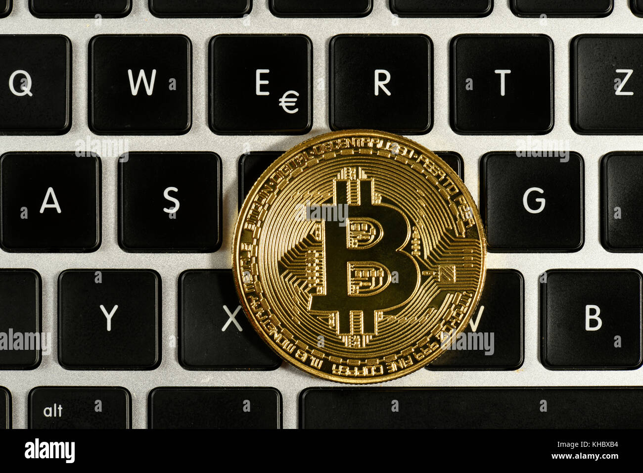 Symbol image digital currency, gold physical coin bitcoin on keyboard Stock Photo - Alamy