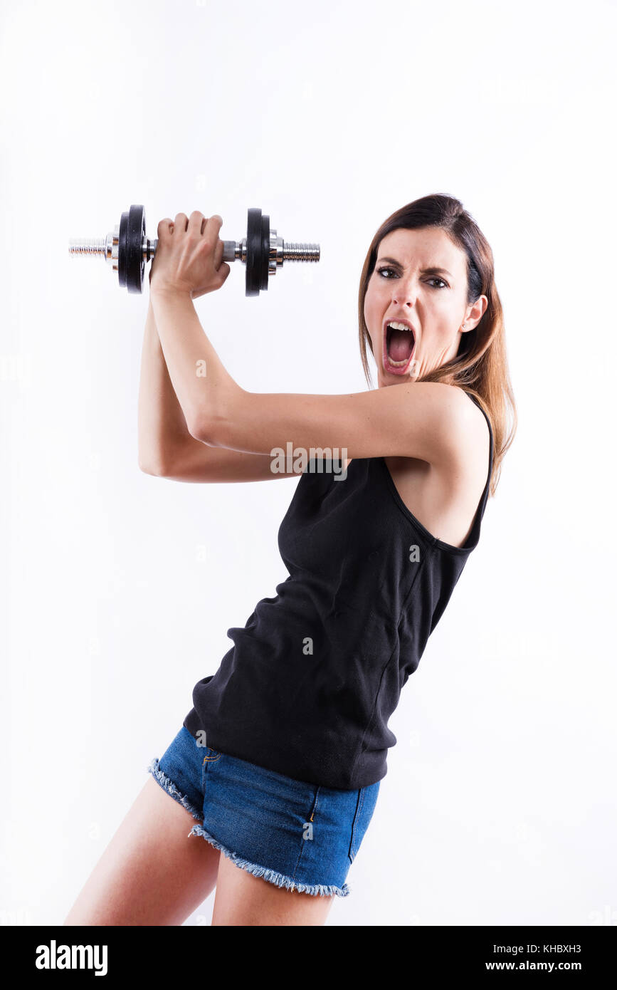A beautiful young woman lifting weight and screaming Stock Photo - Alamy