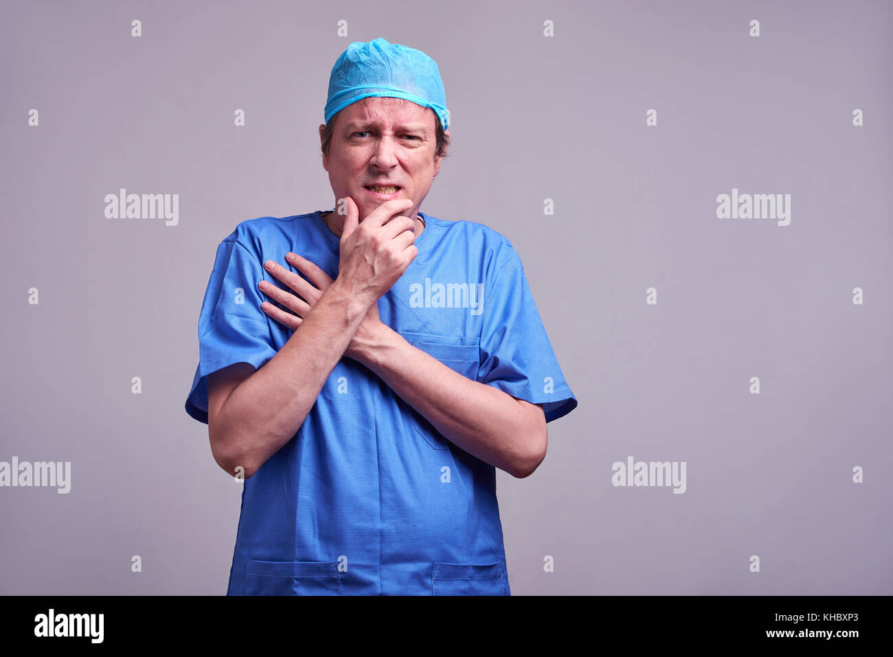 A middle aged male doctor standing and feeling scared Stock Photo - Alamy