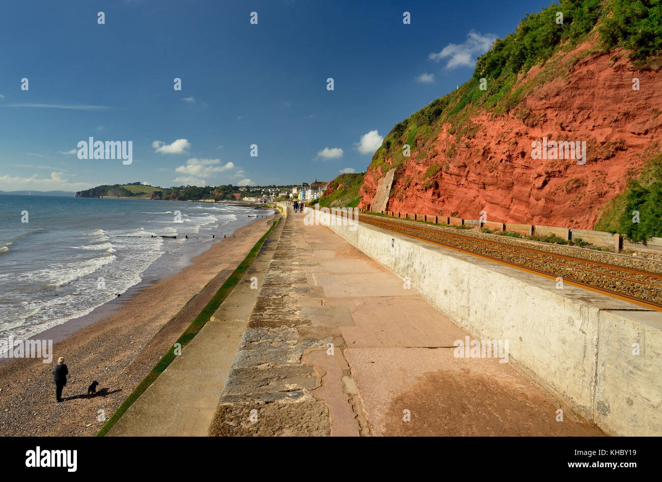 Red sandstone cliffs beside the railway and sea wall at Dawlish Stock ...