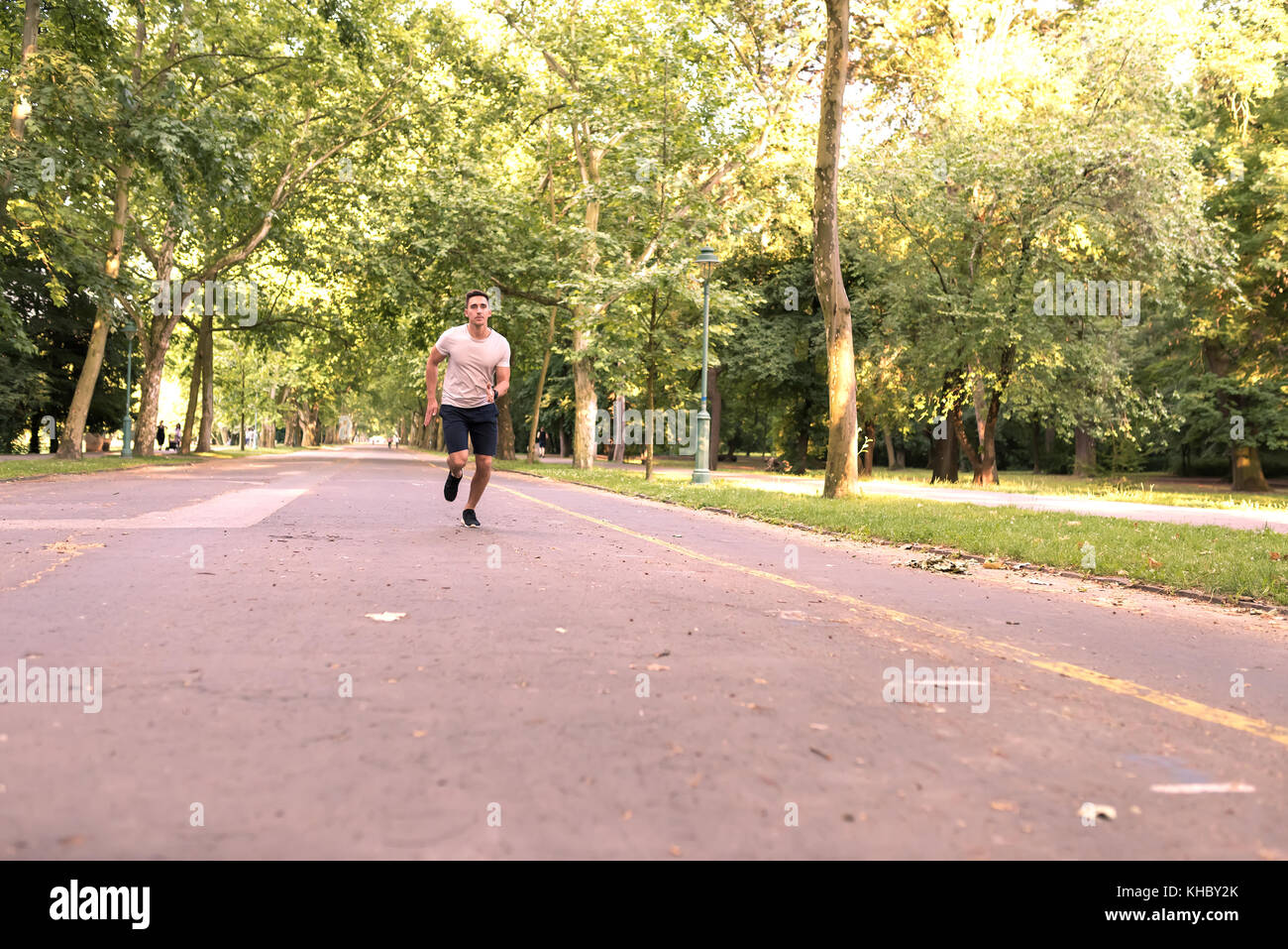 A handsome young man doing sports and jogging in a park Stock Photo - Alamy