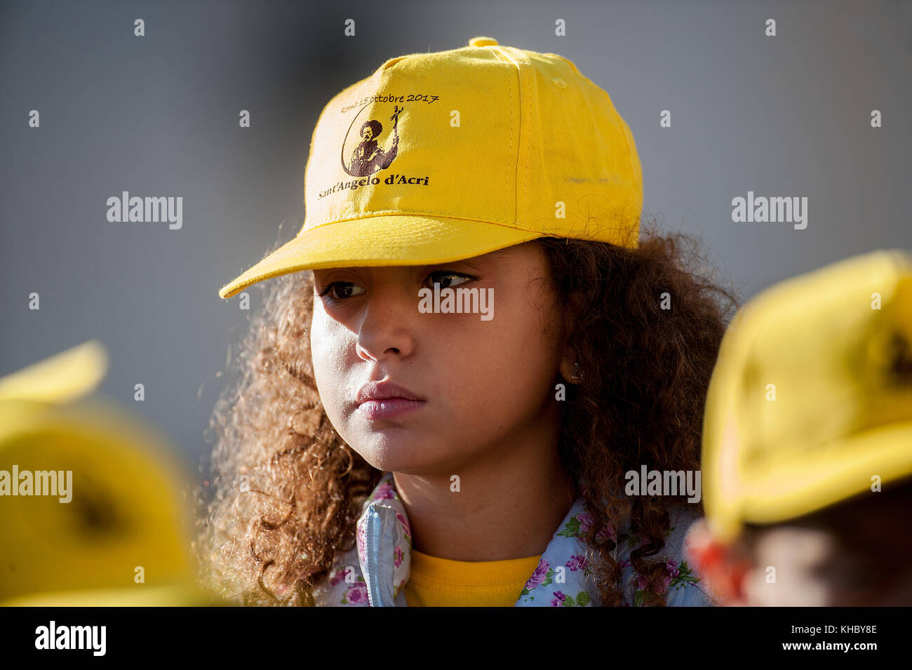 A young girl wearing a hat with the saint Angelo D'Acri during the Mass ...