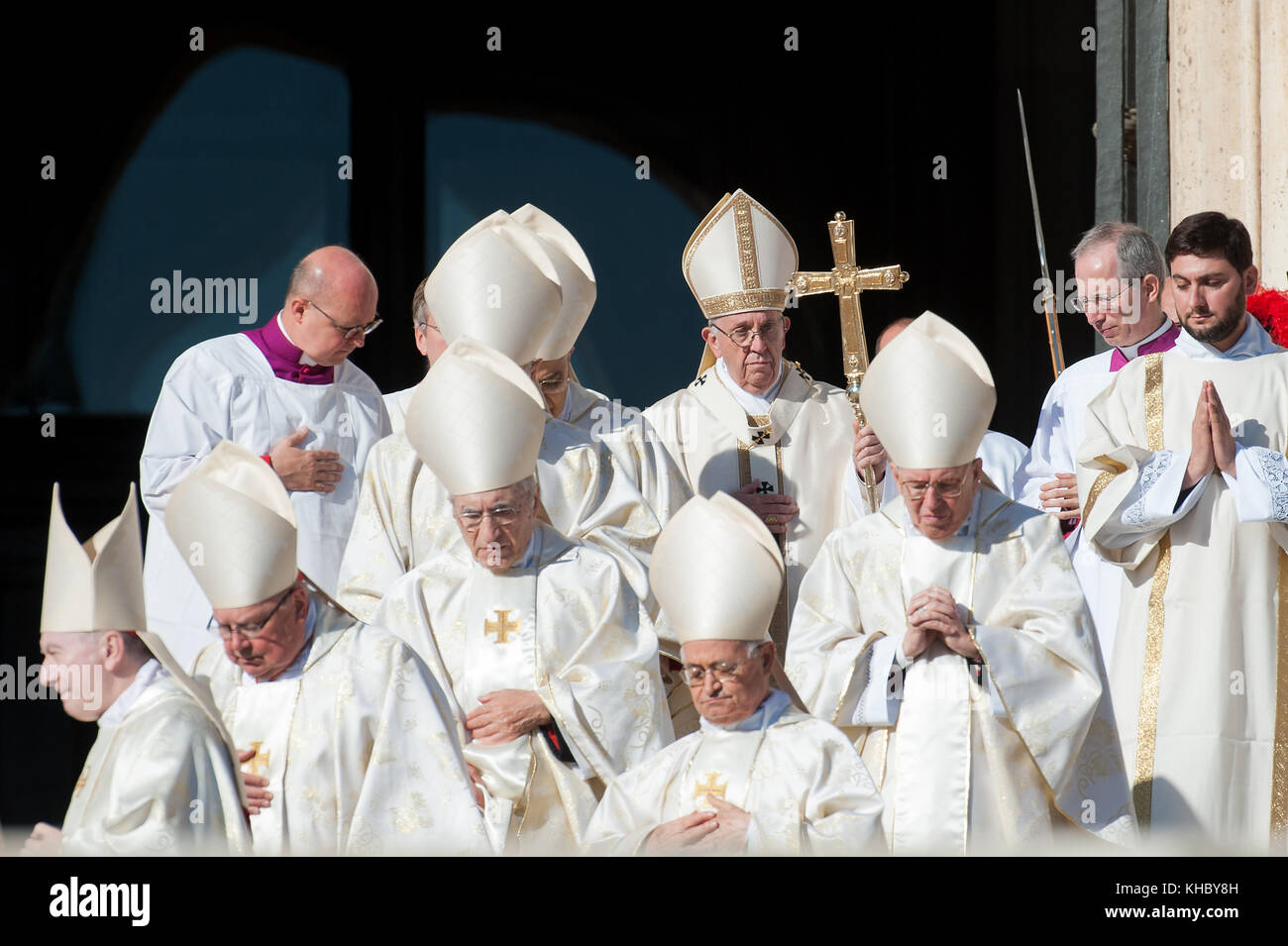 Pope Francis, background center, walks with his pastoral staff as he ...
