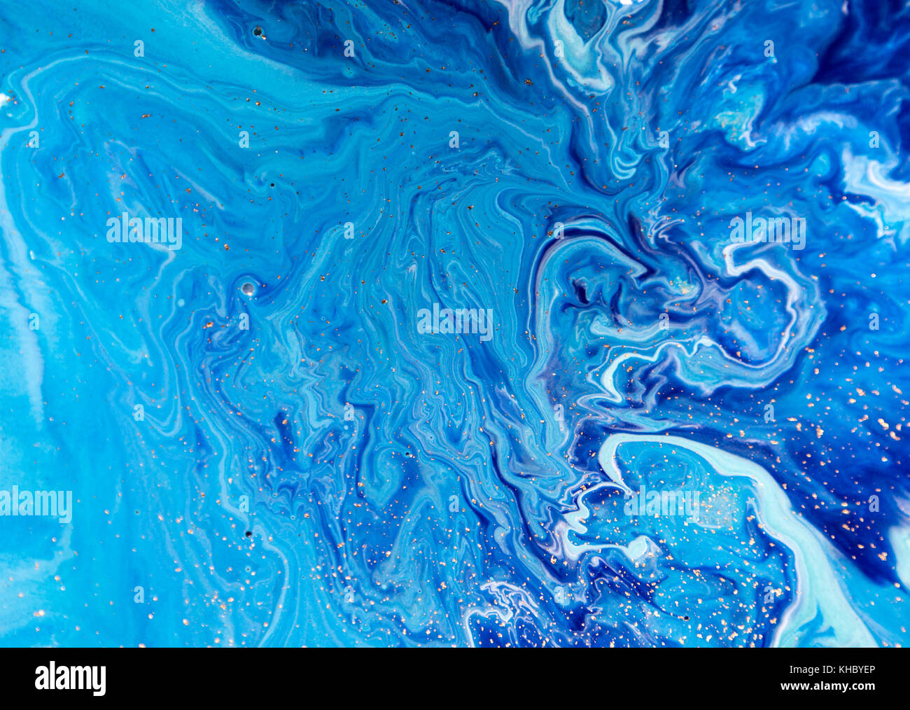 Marbled blue abstract background with golden sequins. Liquid marble ink ...