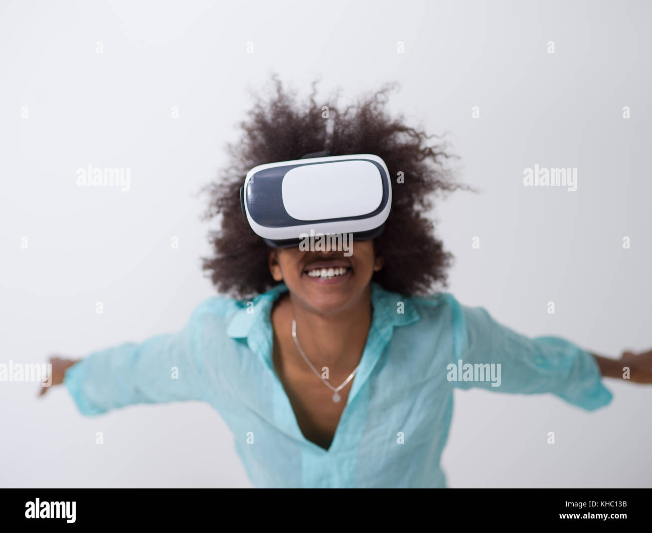 Happy african american girl getting experience using VR headset glasses ...