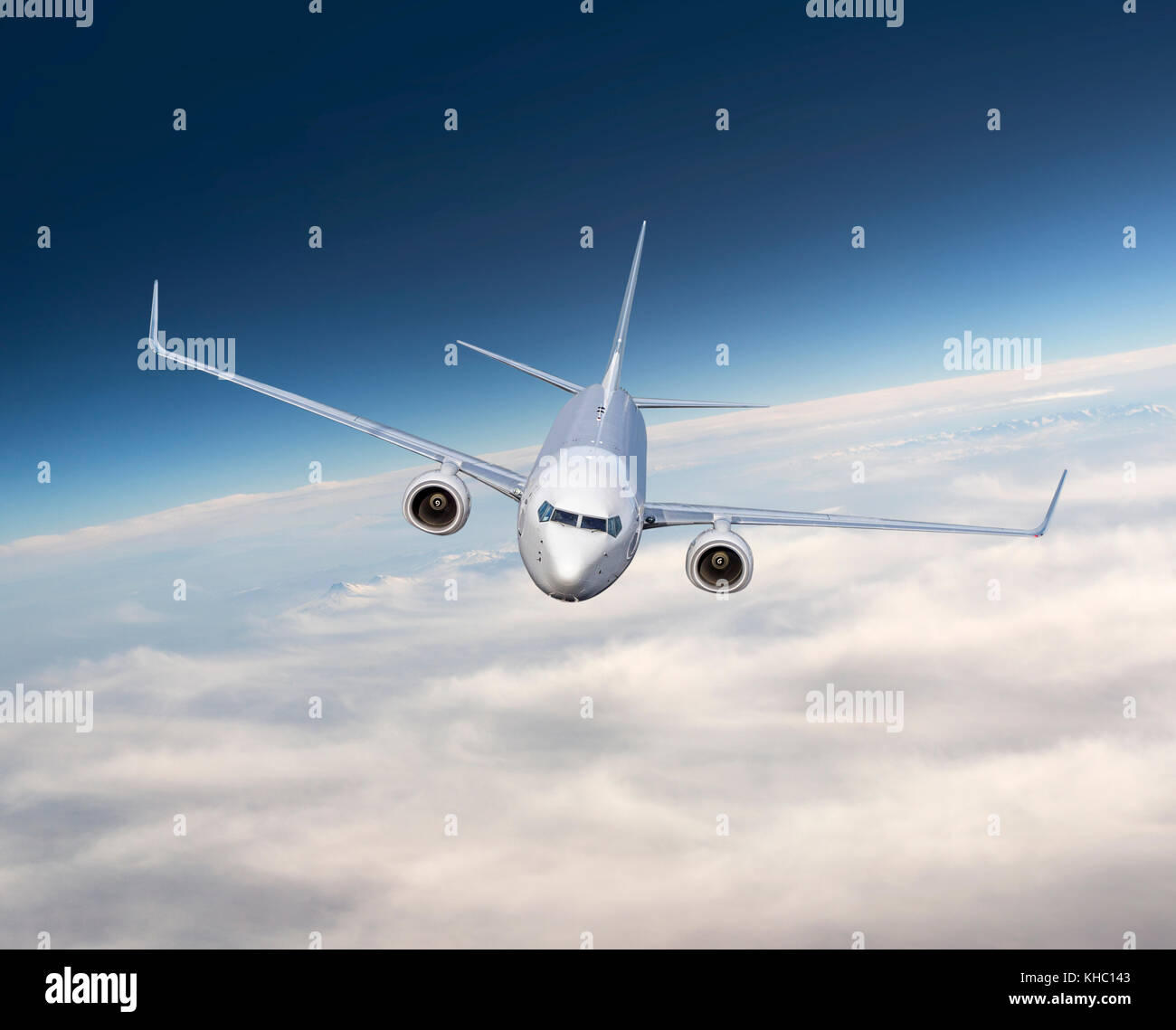 Heavy jumbo jet airplane flying above the clouds Stock Photo - Alamy