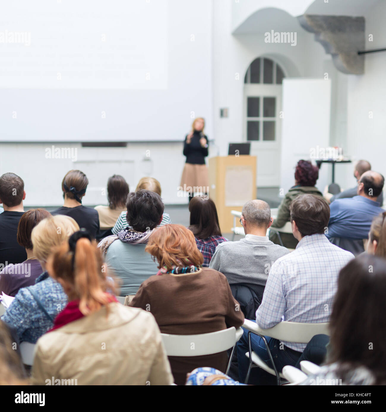 Woman giving presentation on business conference Stock Photo - Alamy