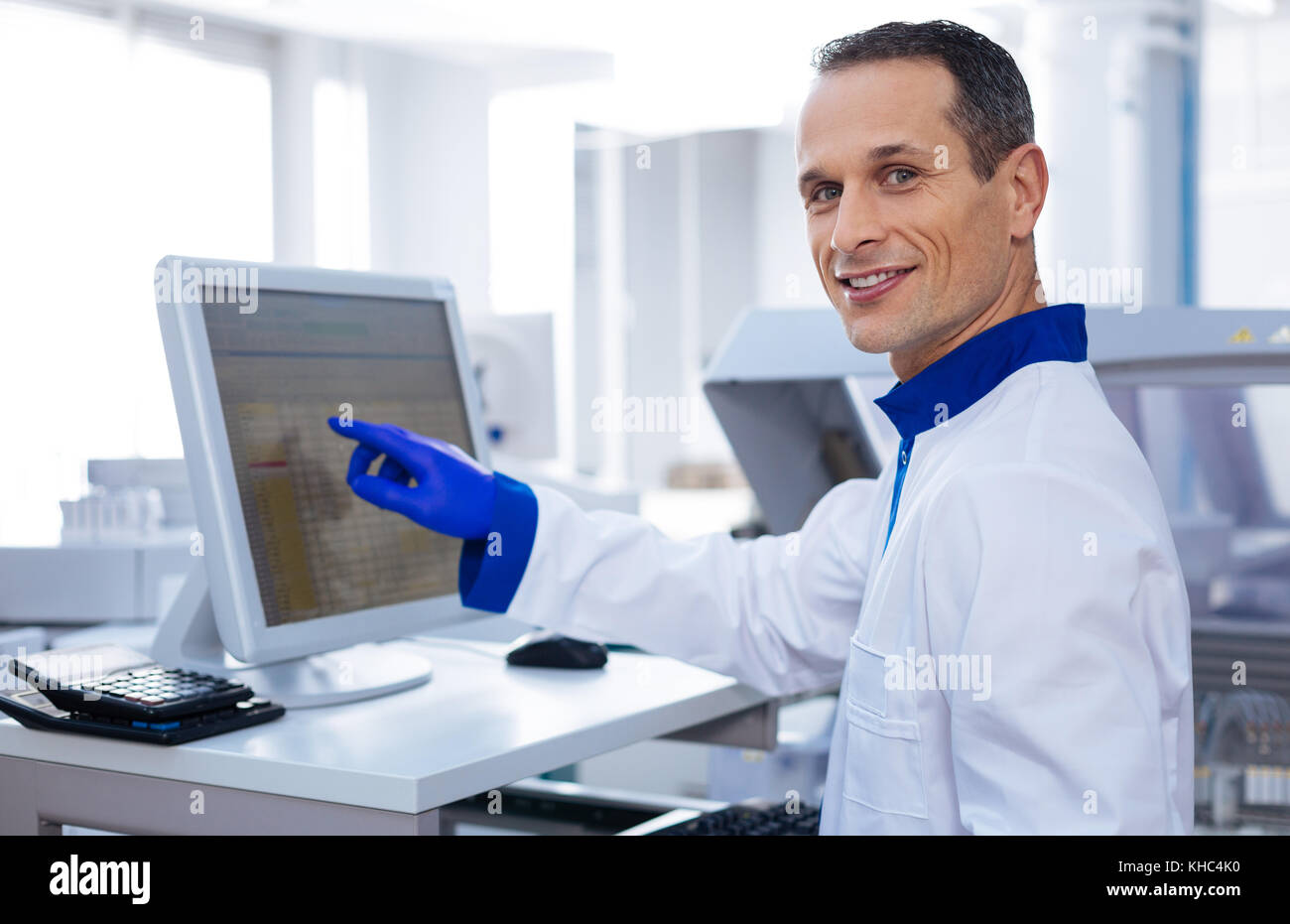Charming smart laboratorian working Stock Photo - Alamy