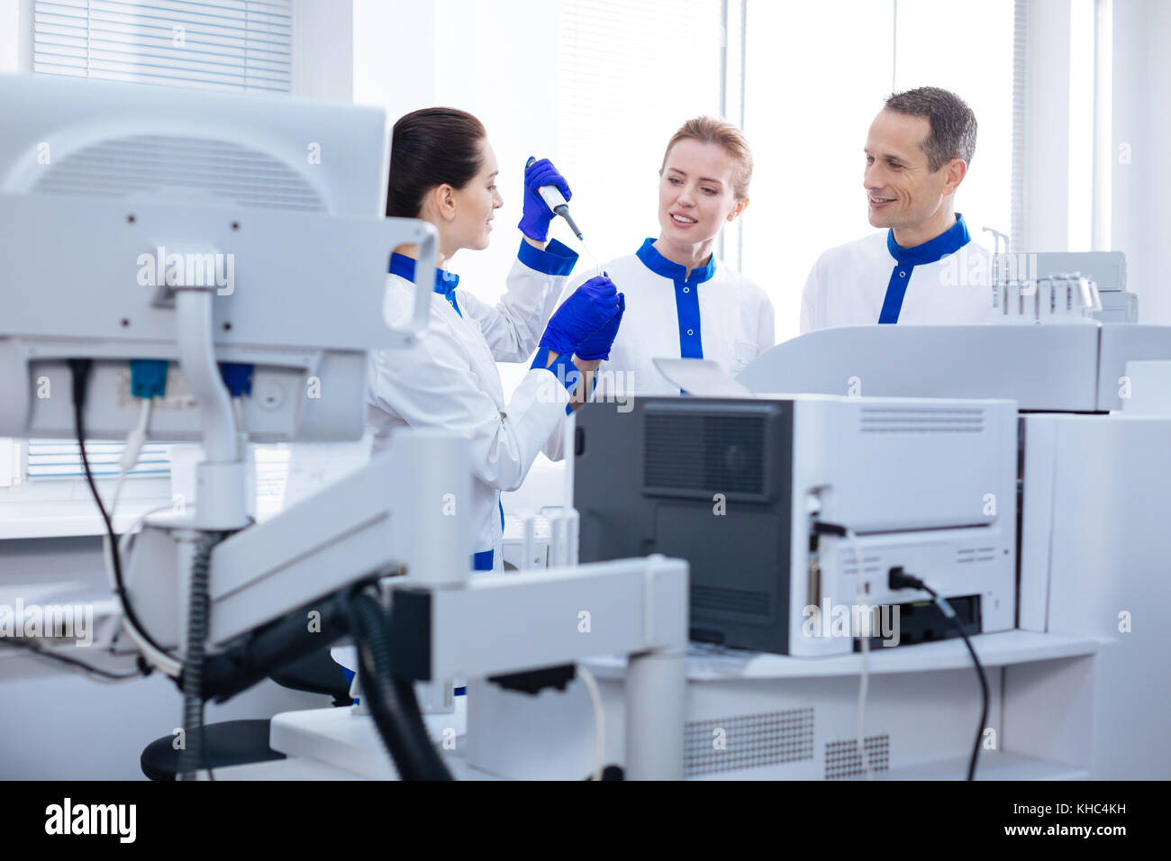 Appealing couple of laboratorians observing intern performance Stock ...