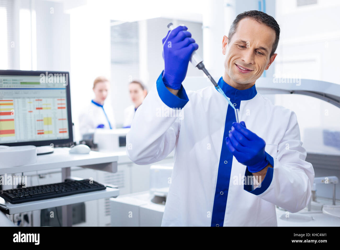 Happy vigorous laboratorian conducting test Stock Photo - Alamy