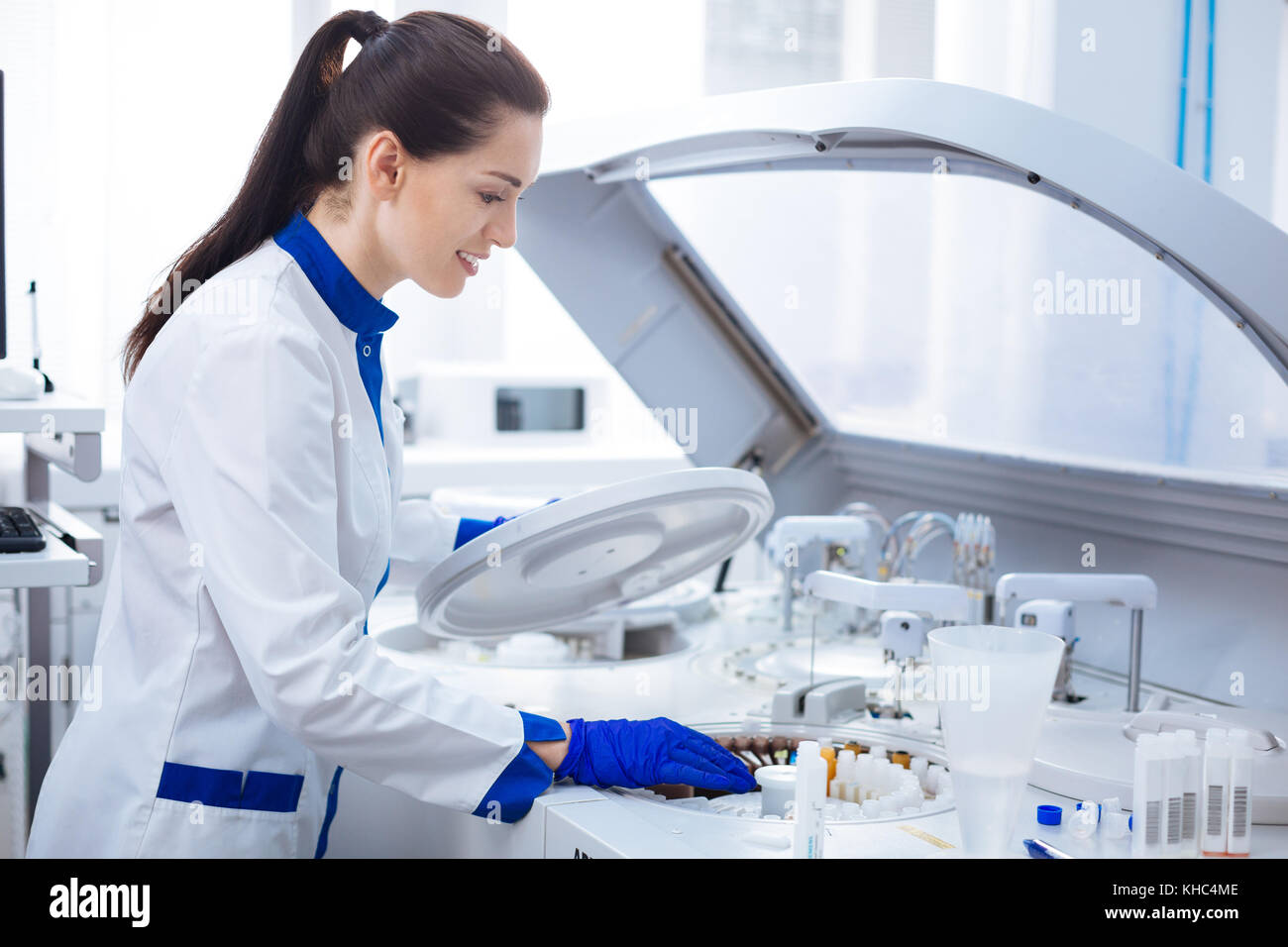 Gentle brunette laboratorian starting centrifuge machine Stock Photo ...