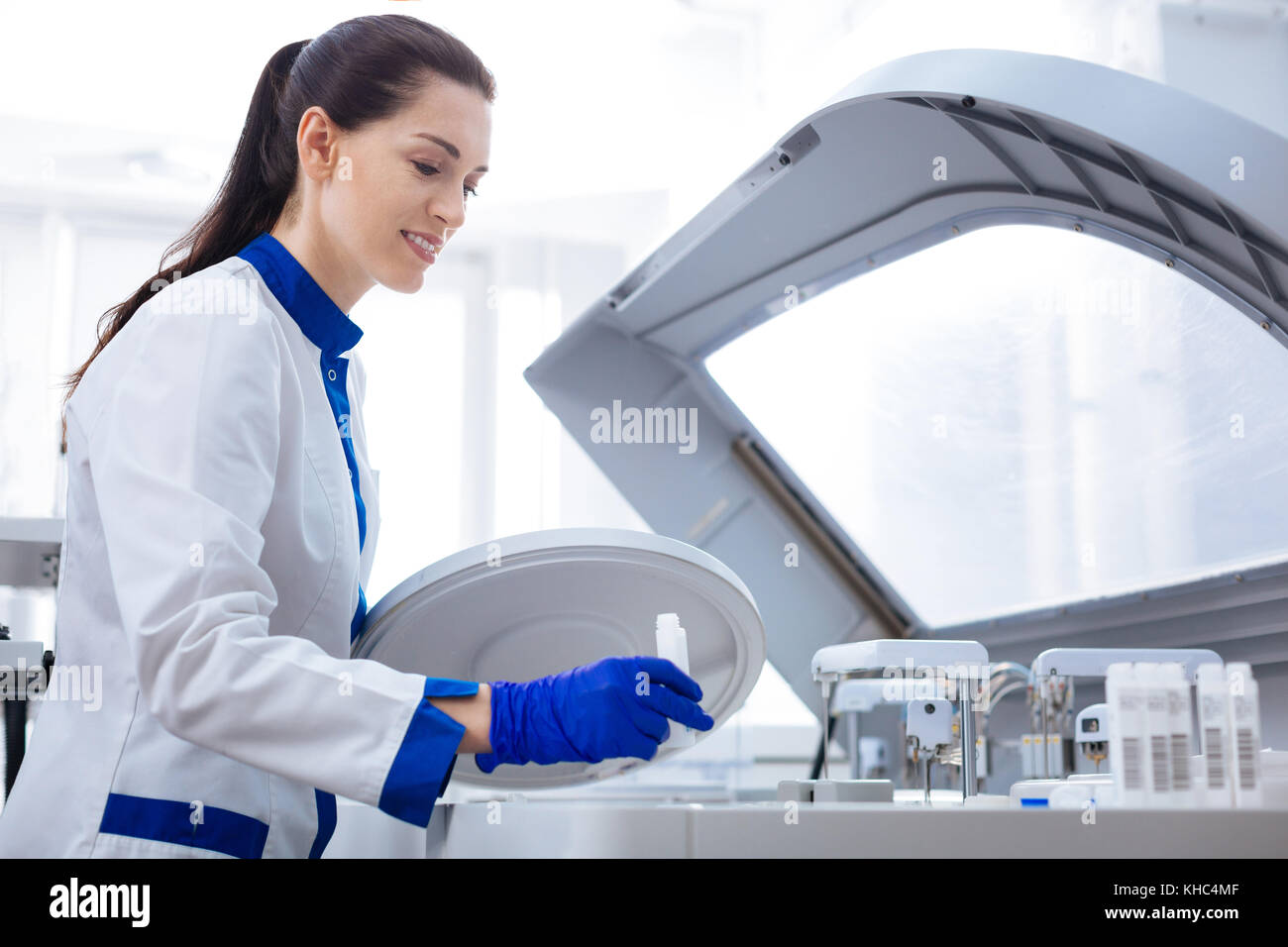 Concentrated laboratory assistant preparing centrifuge machine Stock ...