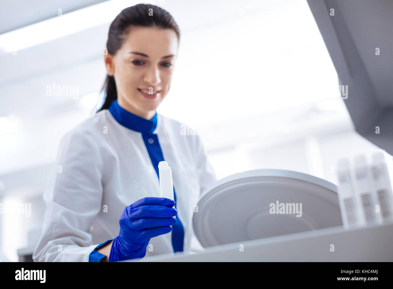 Impressive laboratory assistant holding container Stock Photo - Alamy