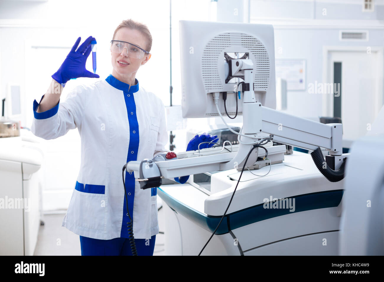 Beautiful laboratory assistant checking result Stock Photo - Alamy