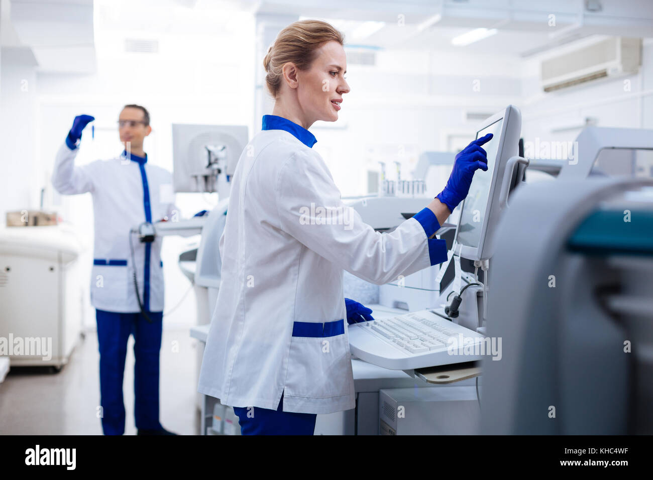 Cute promising researcher filling out the data Stock Photo - Alamy