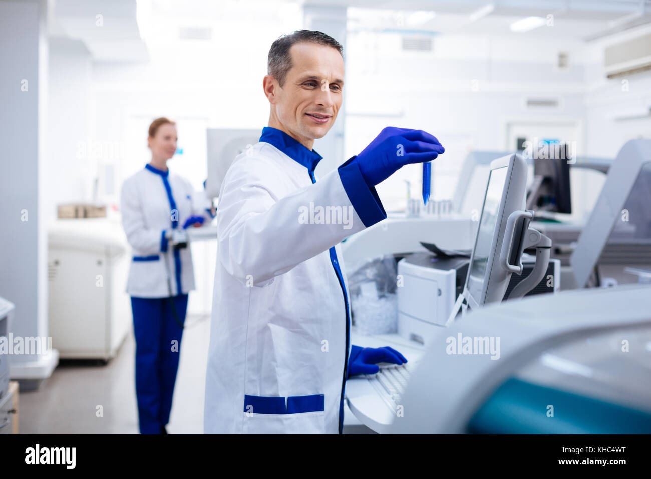Resolute happy researcher reading label on the test tube Stock Photo ...