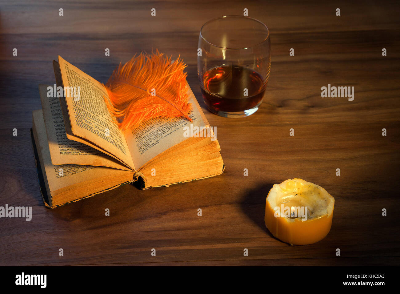 Reading a book with a drink Stock Photo - Alamy